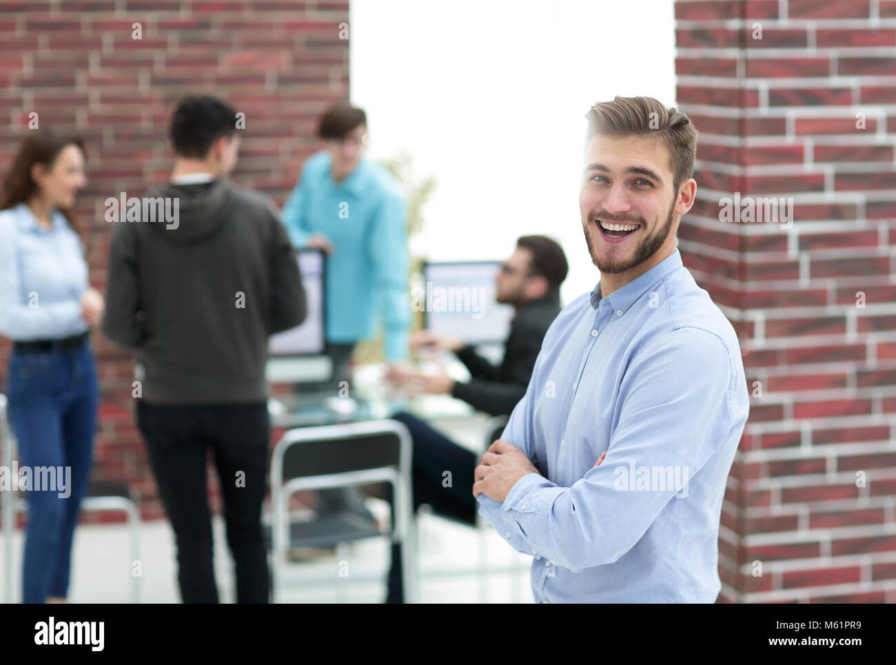 Successful young business man standing with his colleagues in b Stock ...