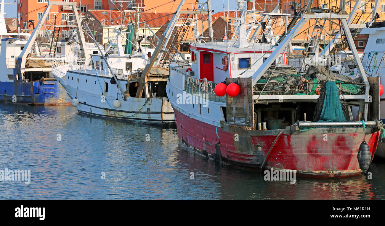 red fishing boat in the waterway with many others boats Stock Photo - Alamy