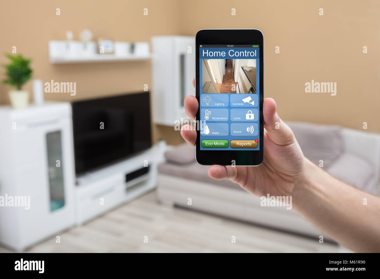 Close-up Of A Human Hand Holding Mobile Phone With Home Control System ...