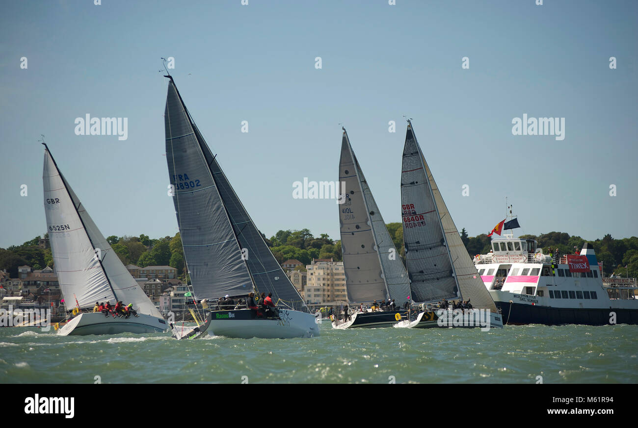 The fleet crosses the finish line of the Round the Island Race 2013 ...