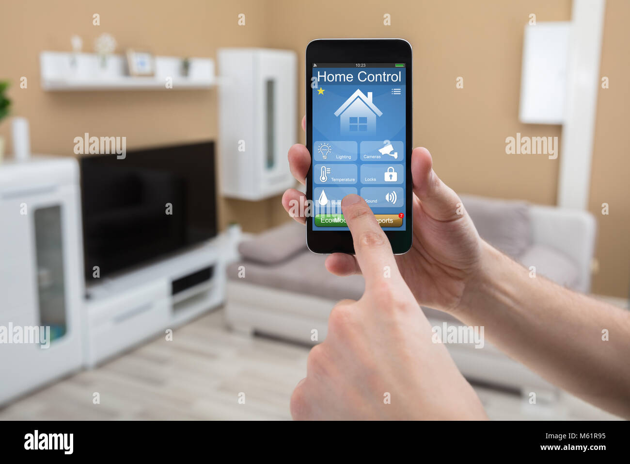 Close-up Of A Human Hand Holding Mobile Phone With Home Control System ...