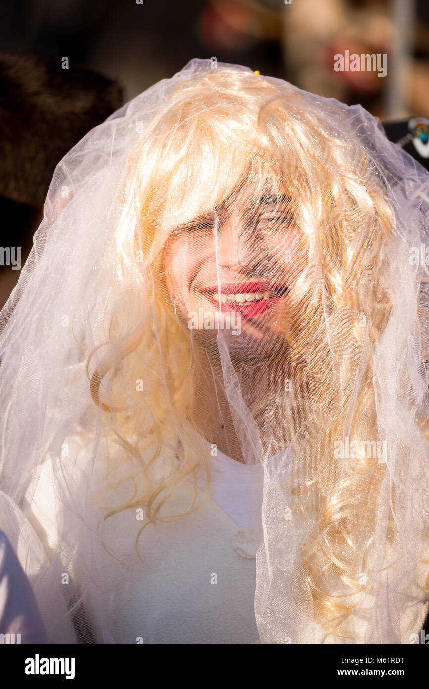 PERNIK, BULGARIA - JANUARY 26, 2018: Man dressed as bride laughs loudly ...