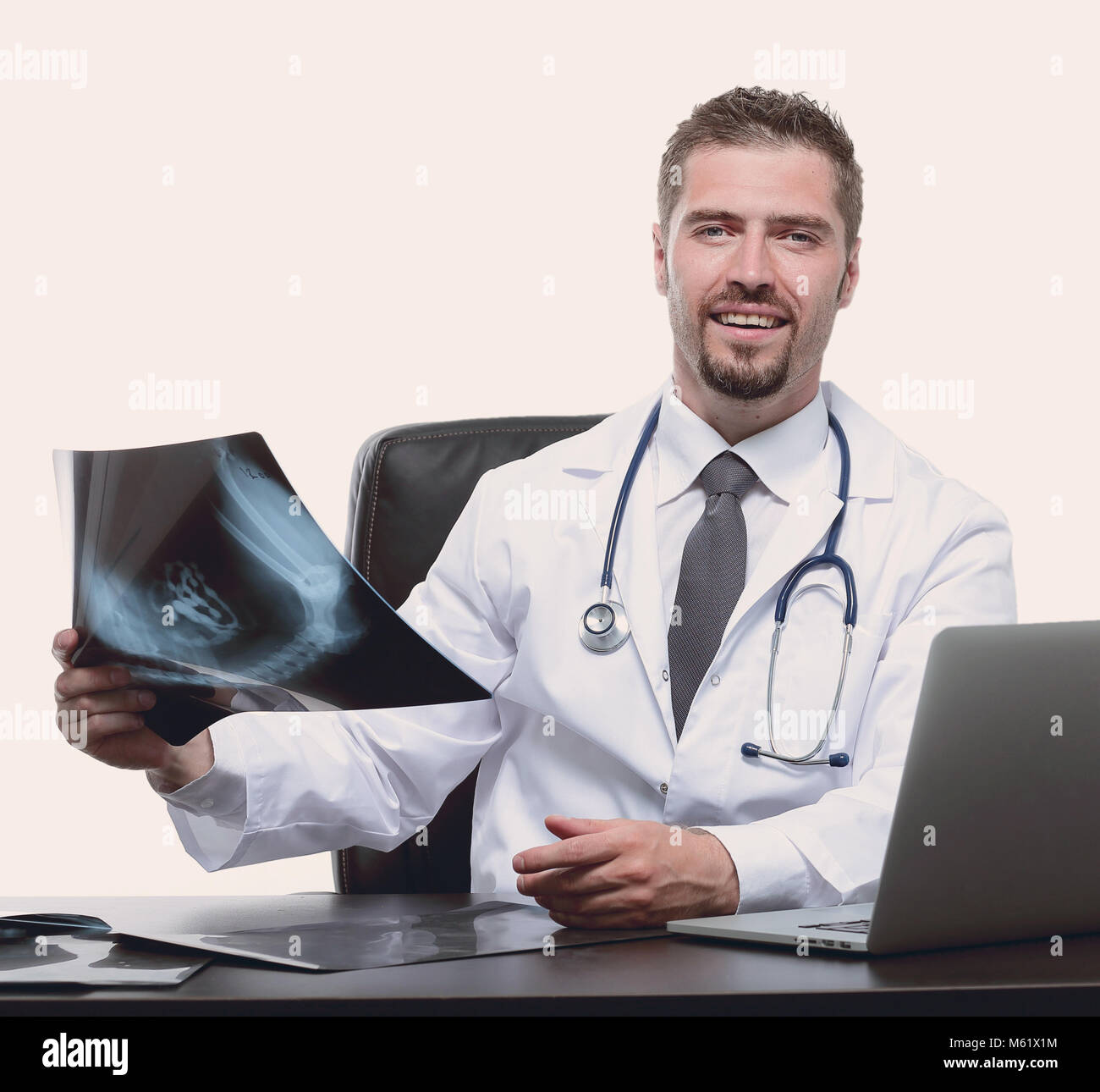 doctor examines an x-ray,sitting behind a Desk Stock Photo - Alamy