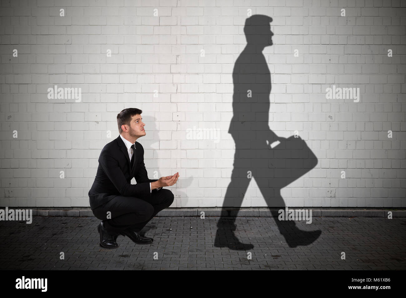 Shadow man holding briefcase hi-res stock photography and images - Alamy
