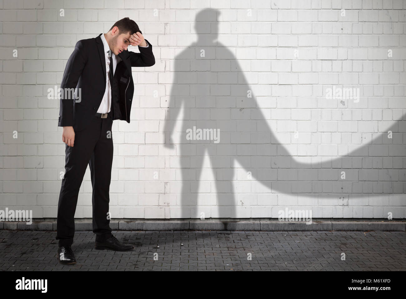 Young Tired Businessman With His Own Shadow In Superhero Cape Stock ...