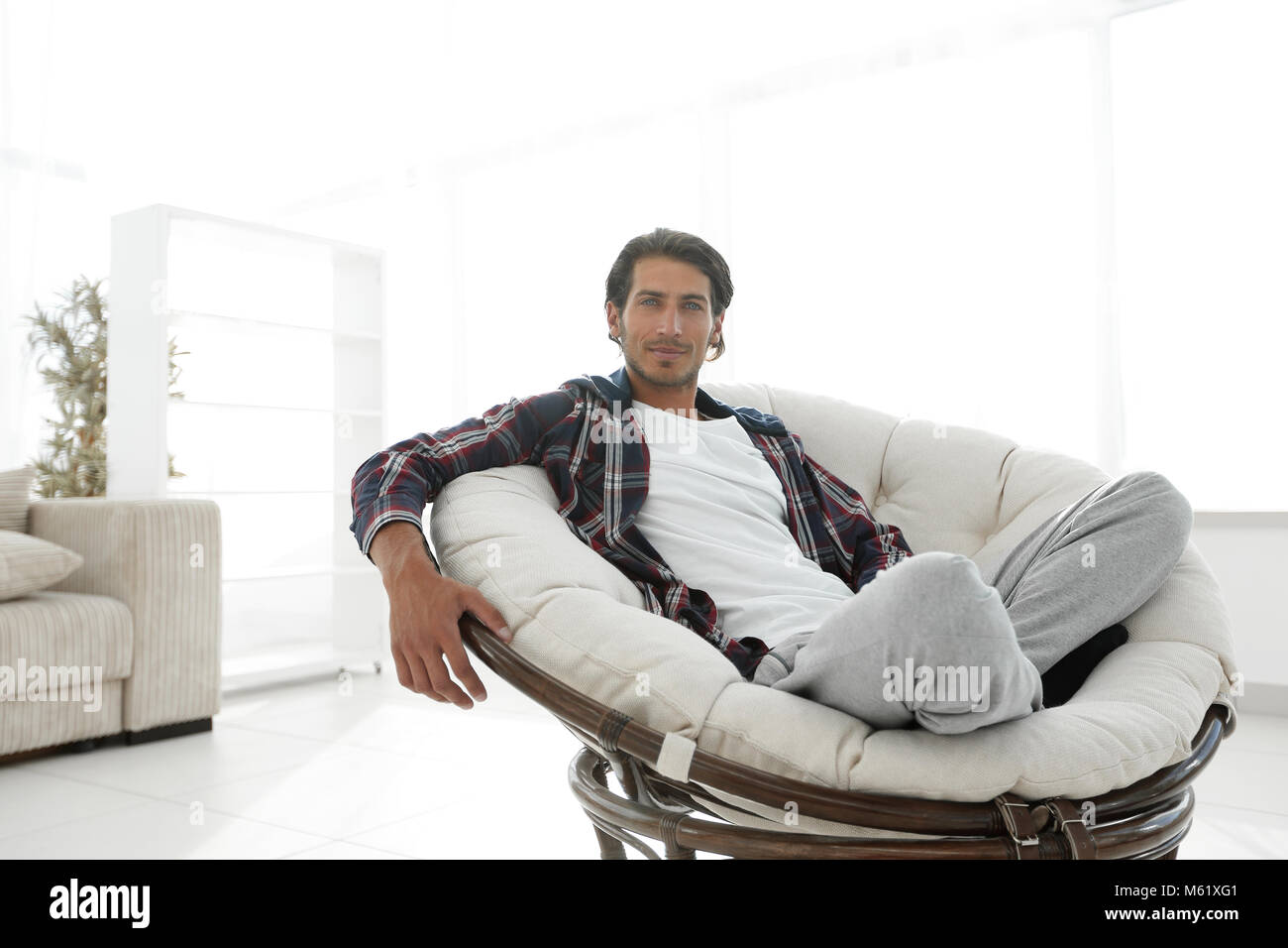 successful guy resting in modern living room Stock Photo - Alamy
