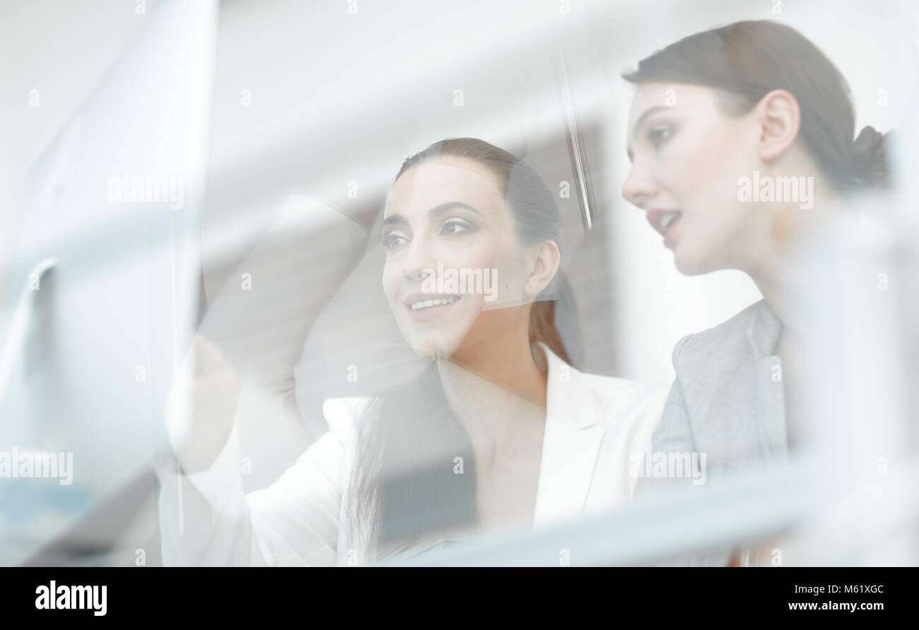 behind the glass.business team sitting at Desk Stock Photo - Alamy