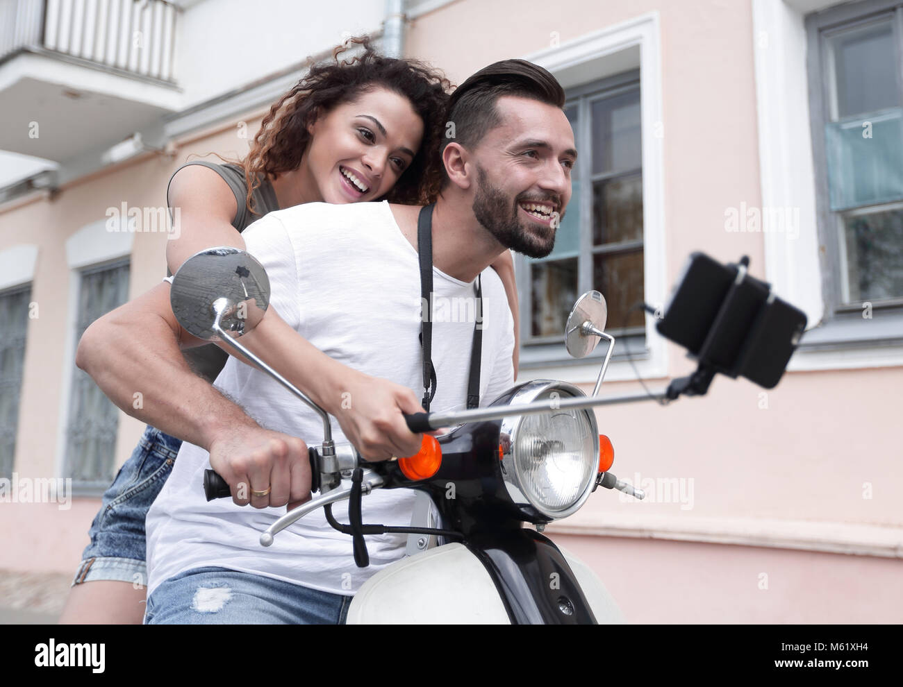 Happy couple on scooter making selfie on smartphone outdoor Stock Photo ...