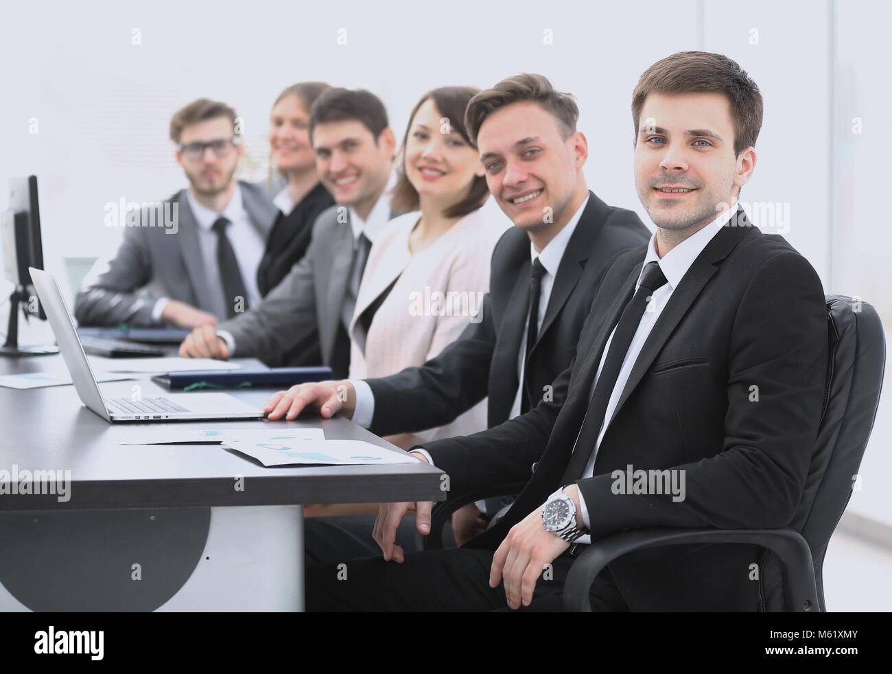 project Manager and professional business team sitting at Desk Stock ...