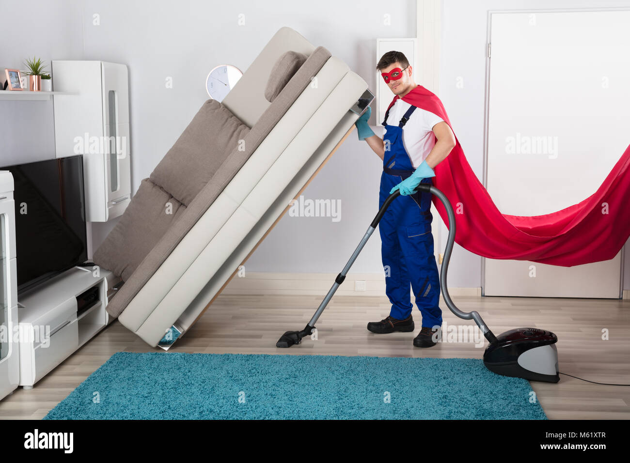 Male Janitor Wearing Superhero Costume Cleaning Wooden Floor With ...