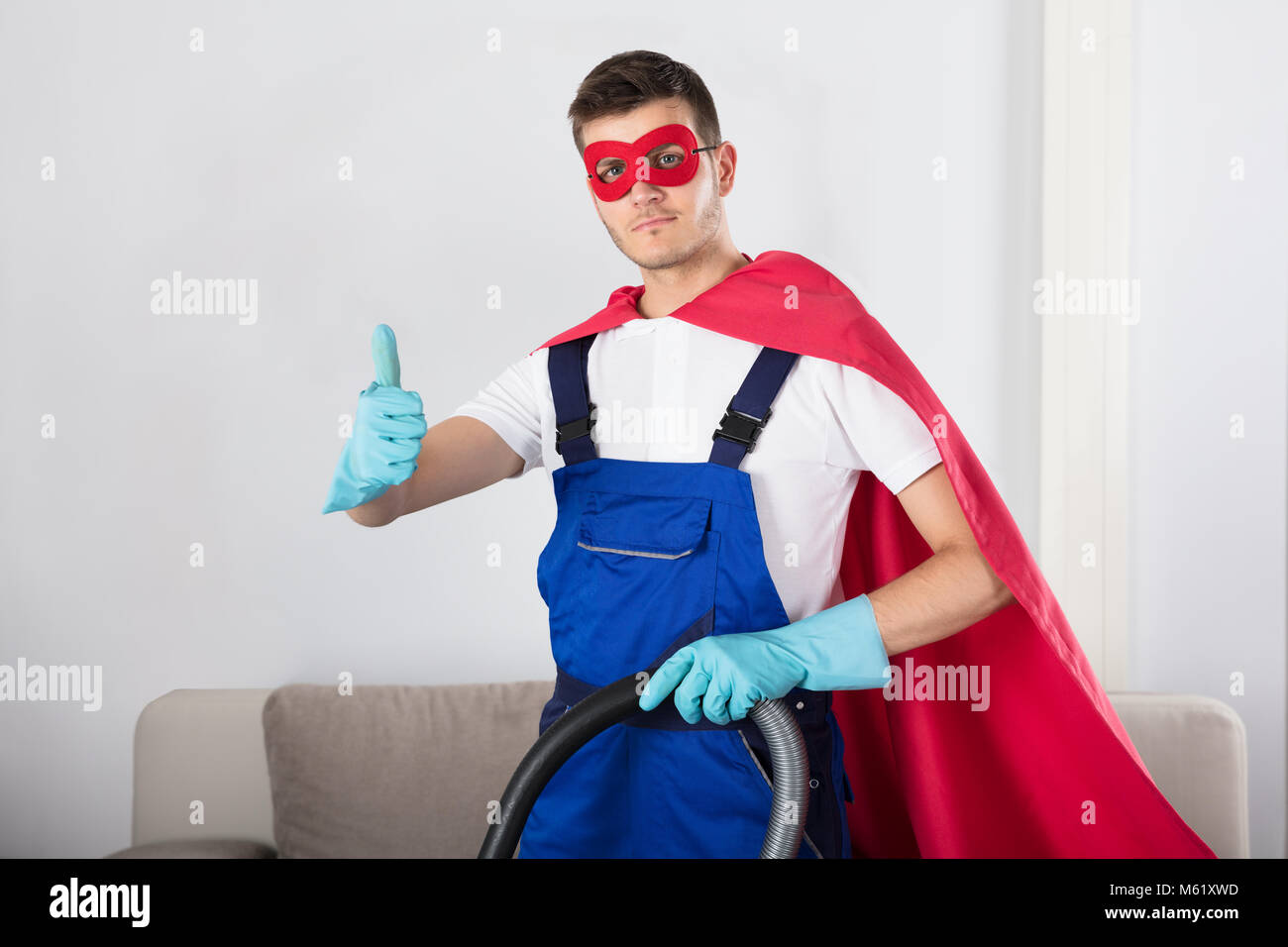Superhero Janitor With Vacuum Cleaner Showing Thumb Up In Living Room ...