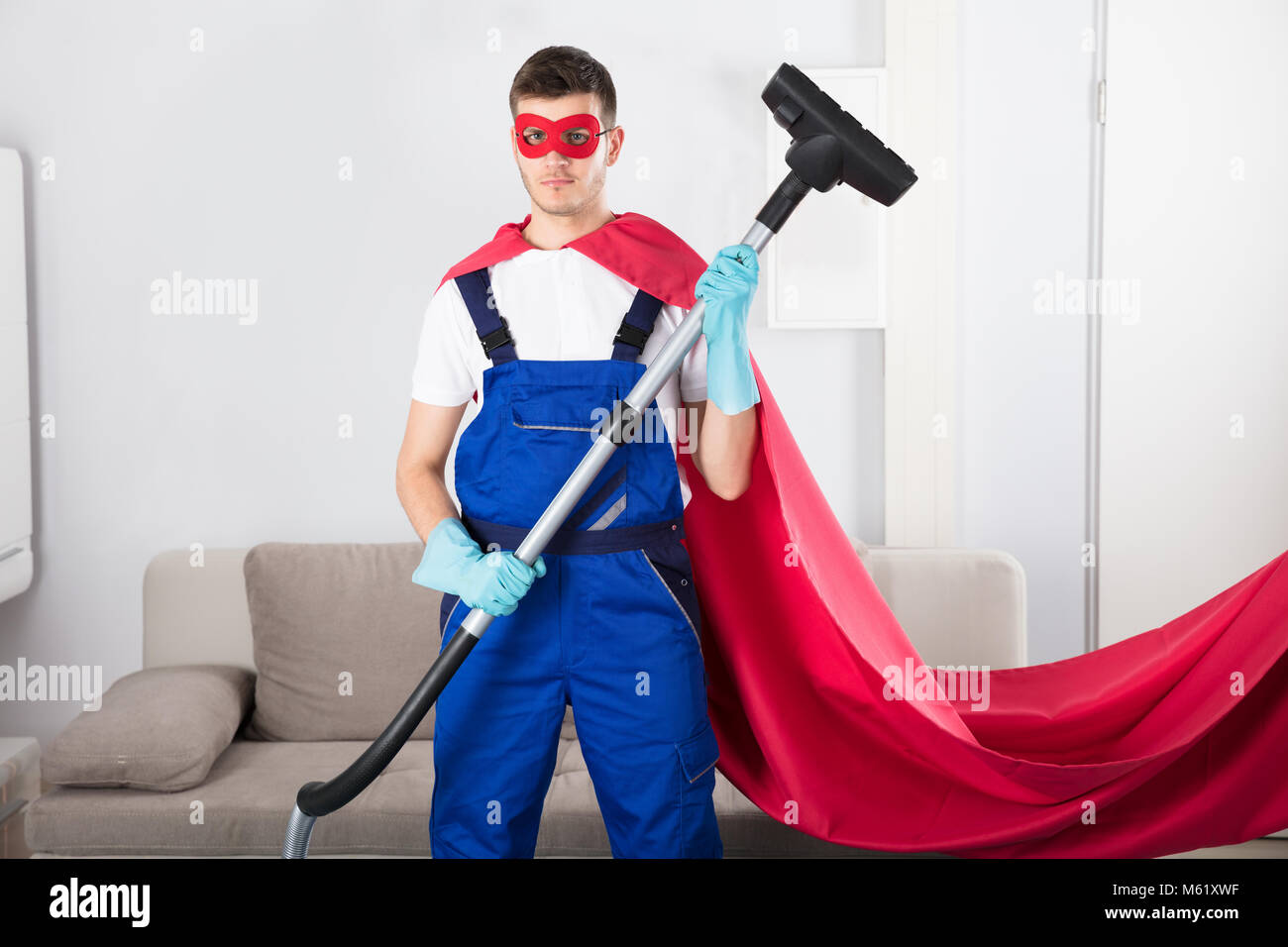 Superhero Janitor With Vacuum Cleaner In Living Room Stock Photo - Alamy