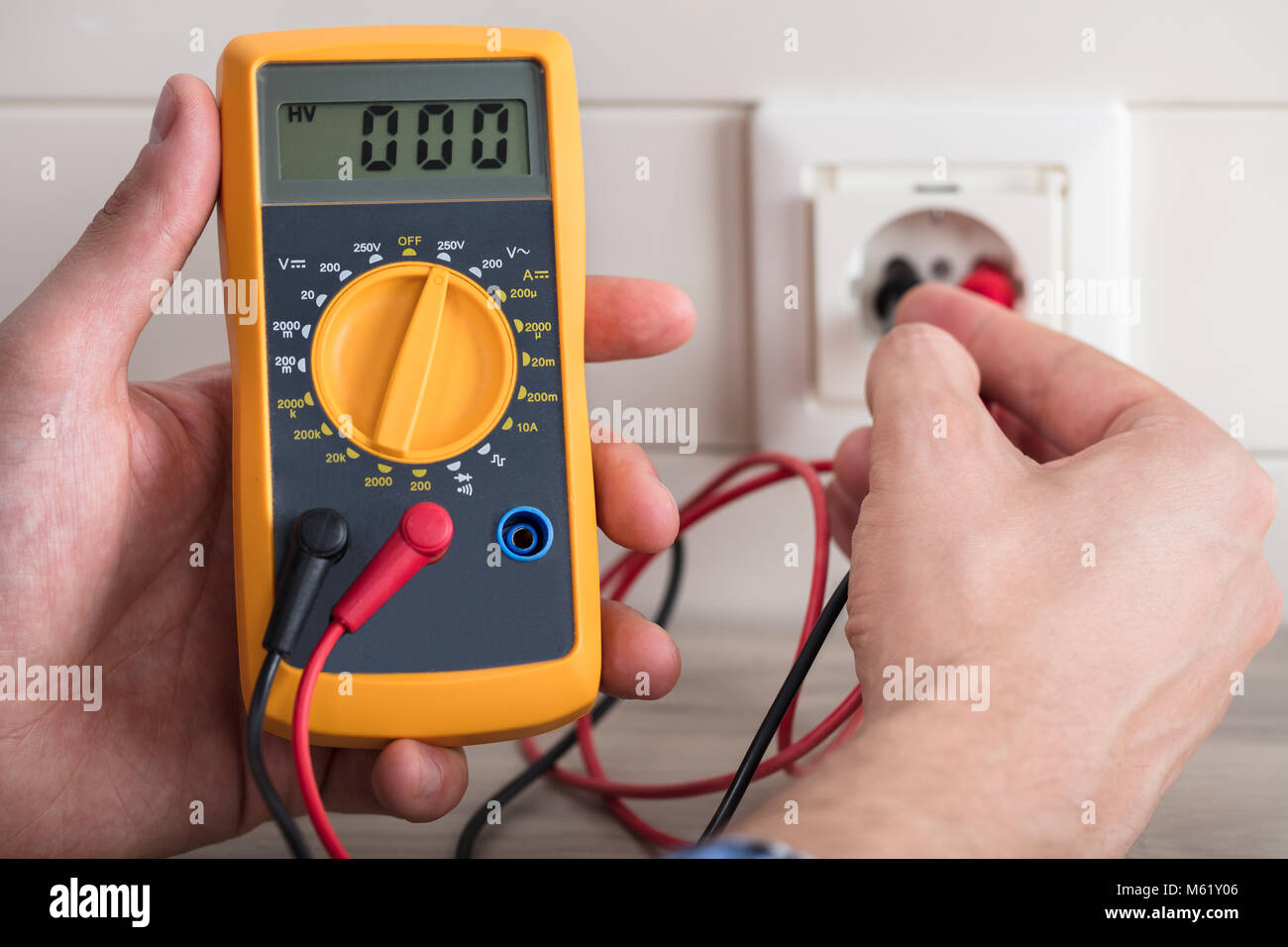 Close-up Of Human Hand And Metering Socket Voltage With Digital ...