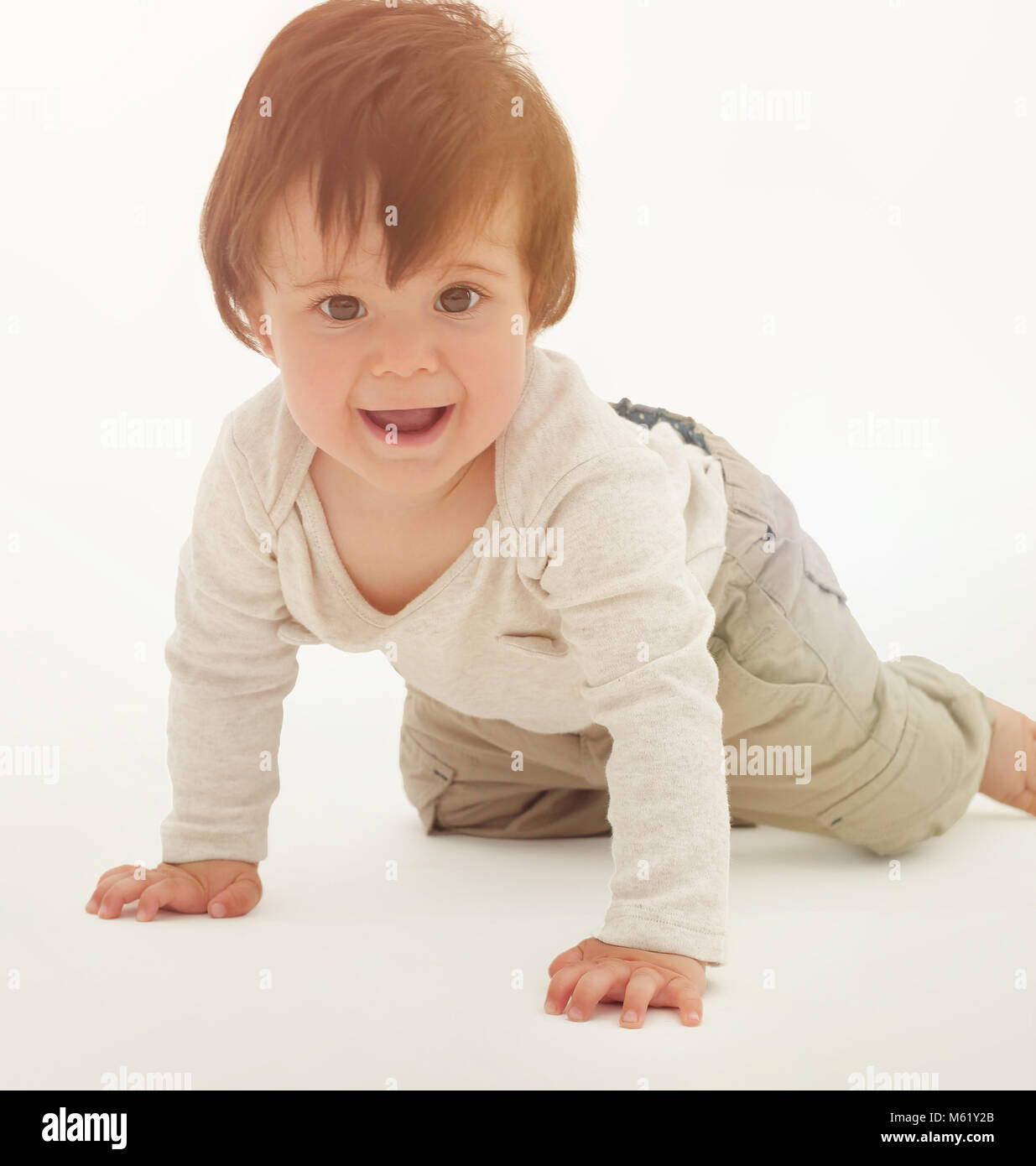 the baby learns to crawl isolated on white background Stock Photo - Alamy