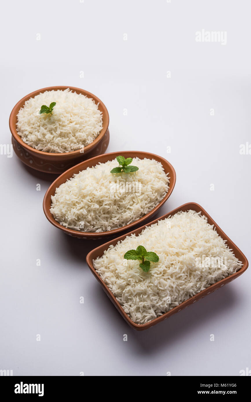 Cooked plain white basmati rice in terracotta bowl over plain or wooden ...