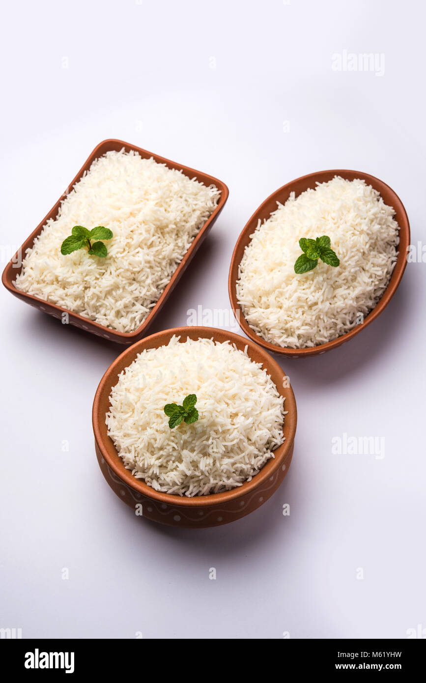 Cooked plain white basmati rice in terracotta bowl over plain or wooden ...