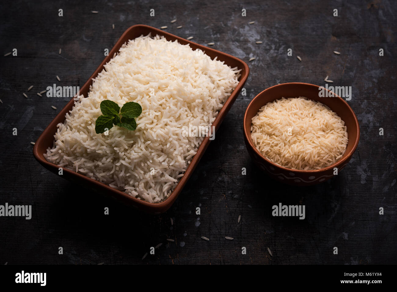 Cooked plain white basmati rice in terracotta bowl over plain or wooden ...