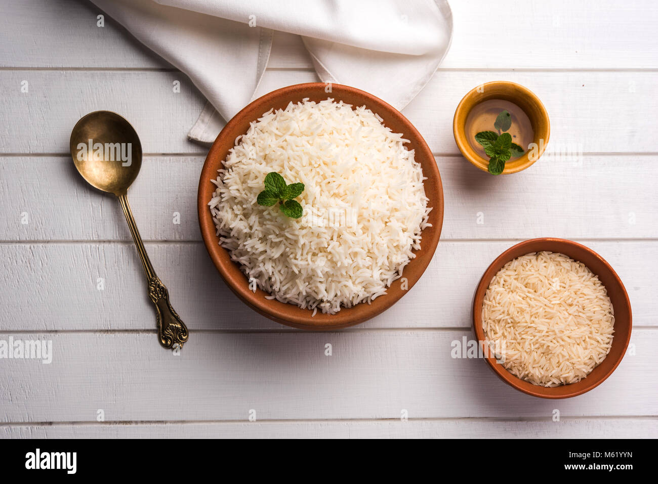 Cooked plain white basmati rice in terracotta bowl over plain or wooden ...