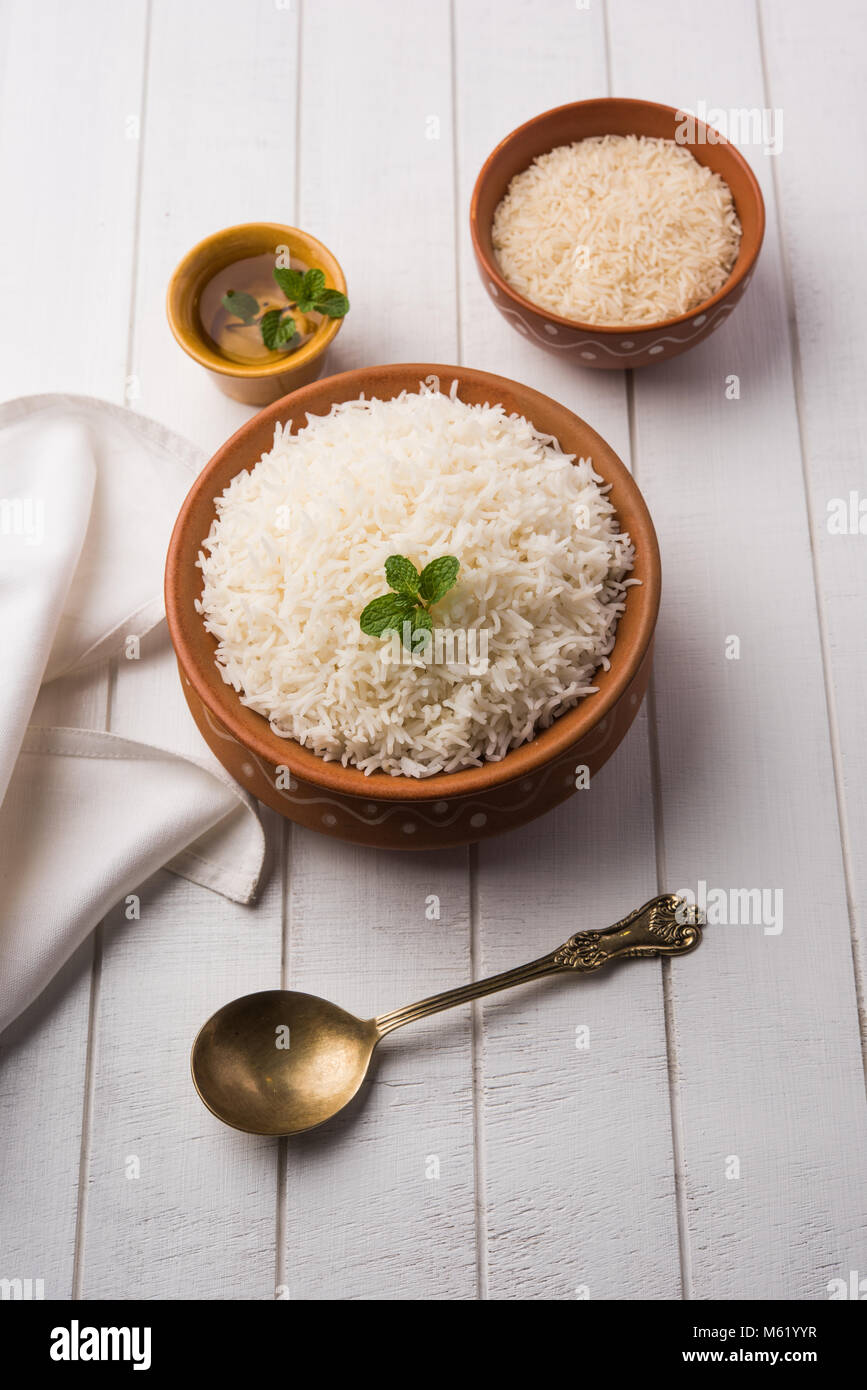 Cooked plain white basmati rice in terracotta bowl over plain or wooden ...
