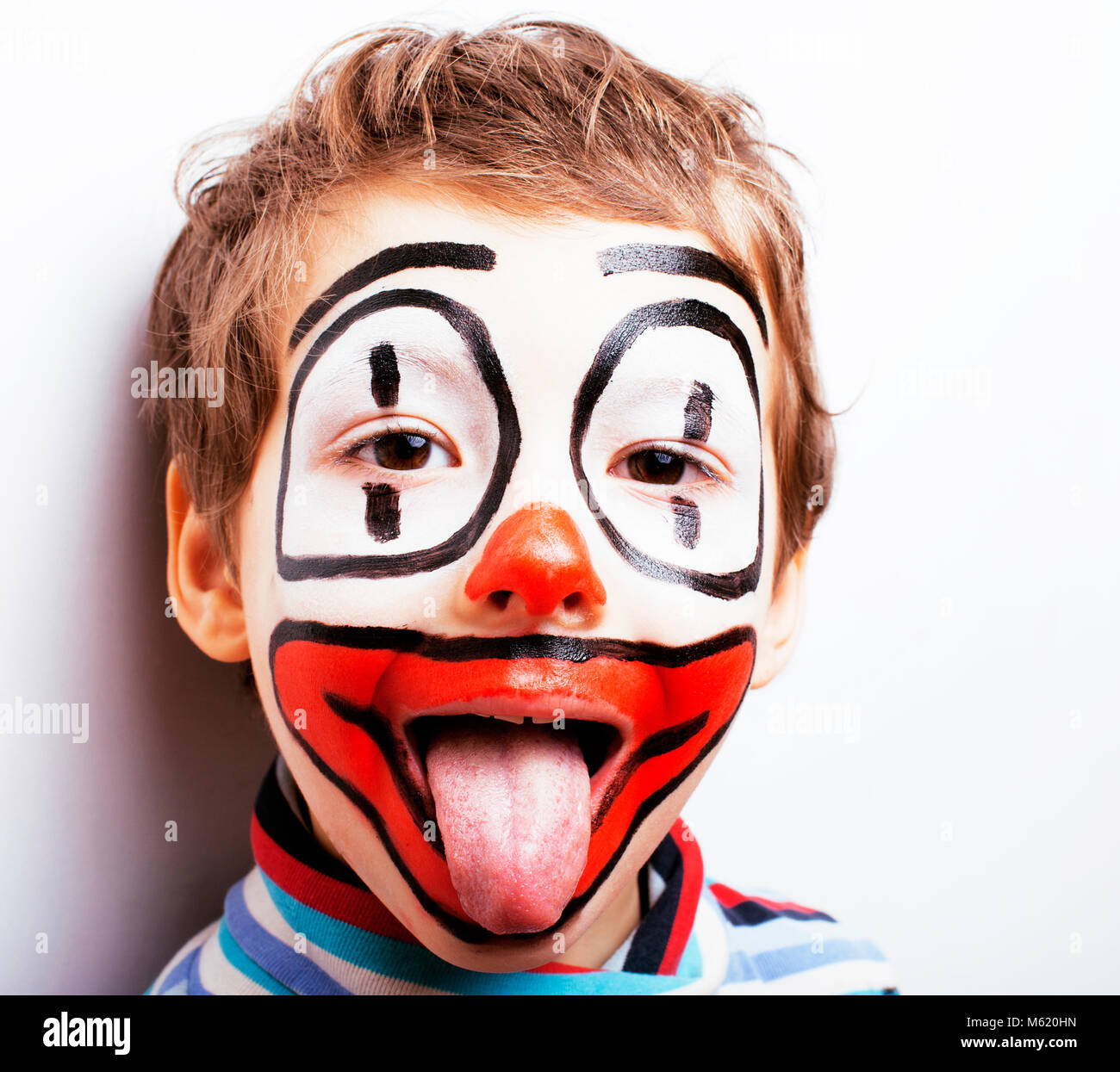 little cute real boy with facepaint like clown, pantomimic expressions ...