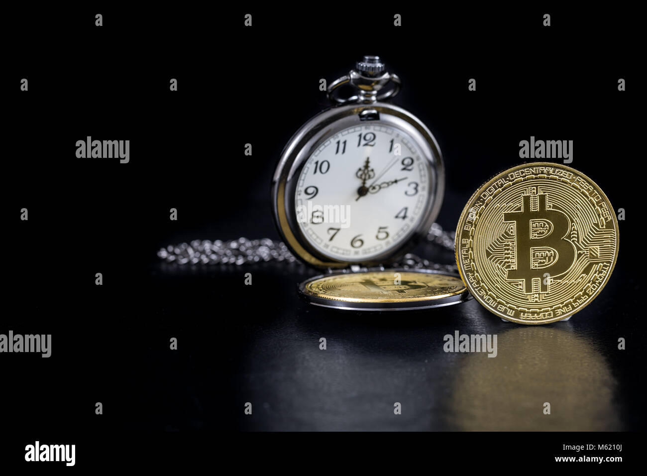 Single golden bitcoin and pocket watch on black background Stock Photo ...