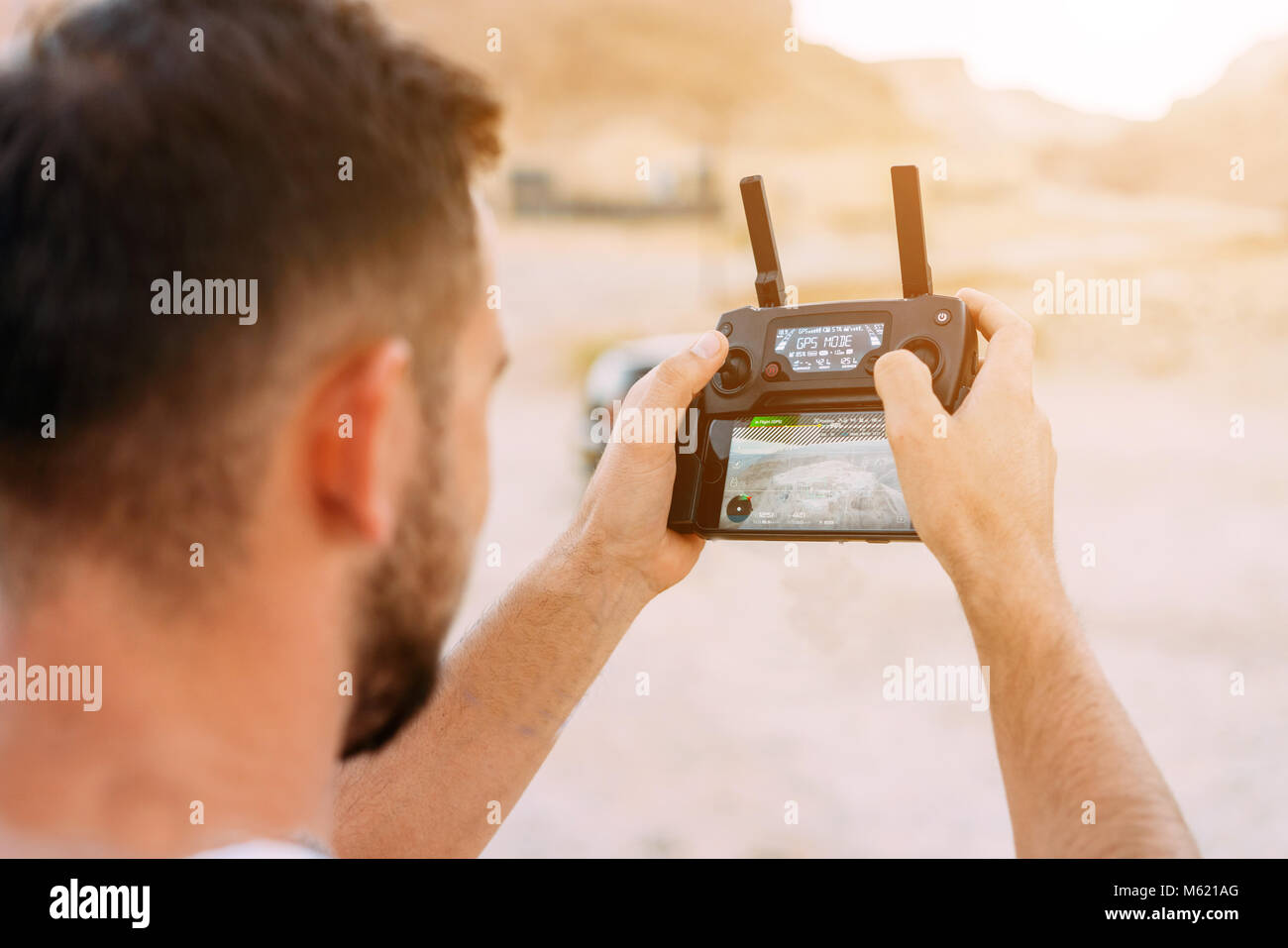 Guy controls drone with remote control Stock Photo - Alamy