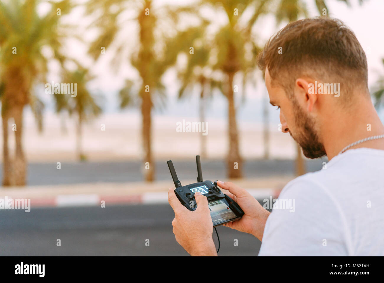 Guy controls drone with remote control Stock Photo - Alamy