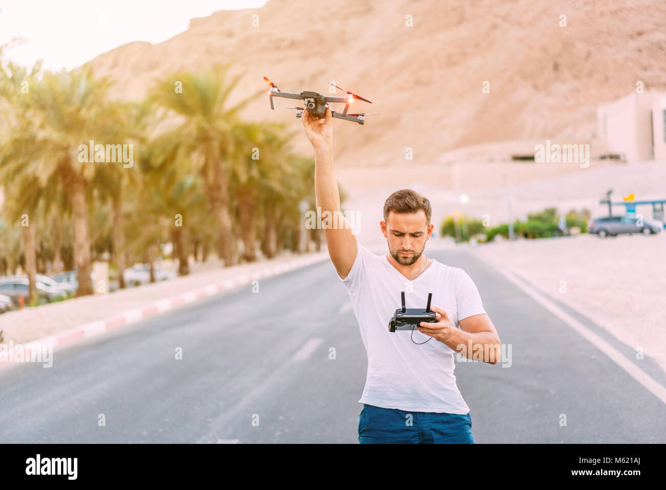 Young man holding drone before flight at nature Stock Photo - Alamy