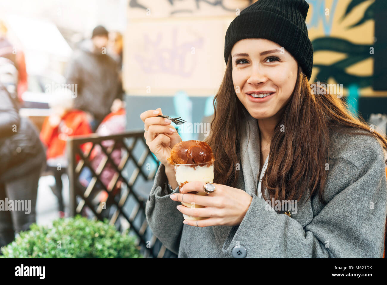Happy girl eating dessert in a cafe Stock Photo - Alamy