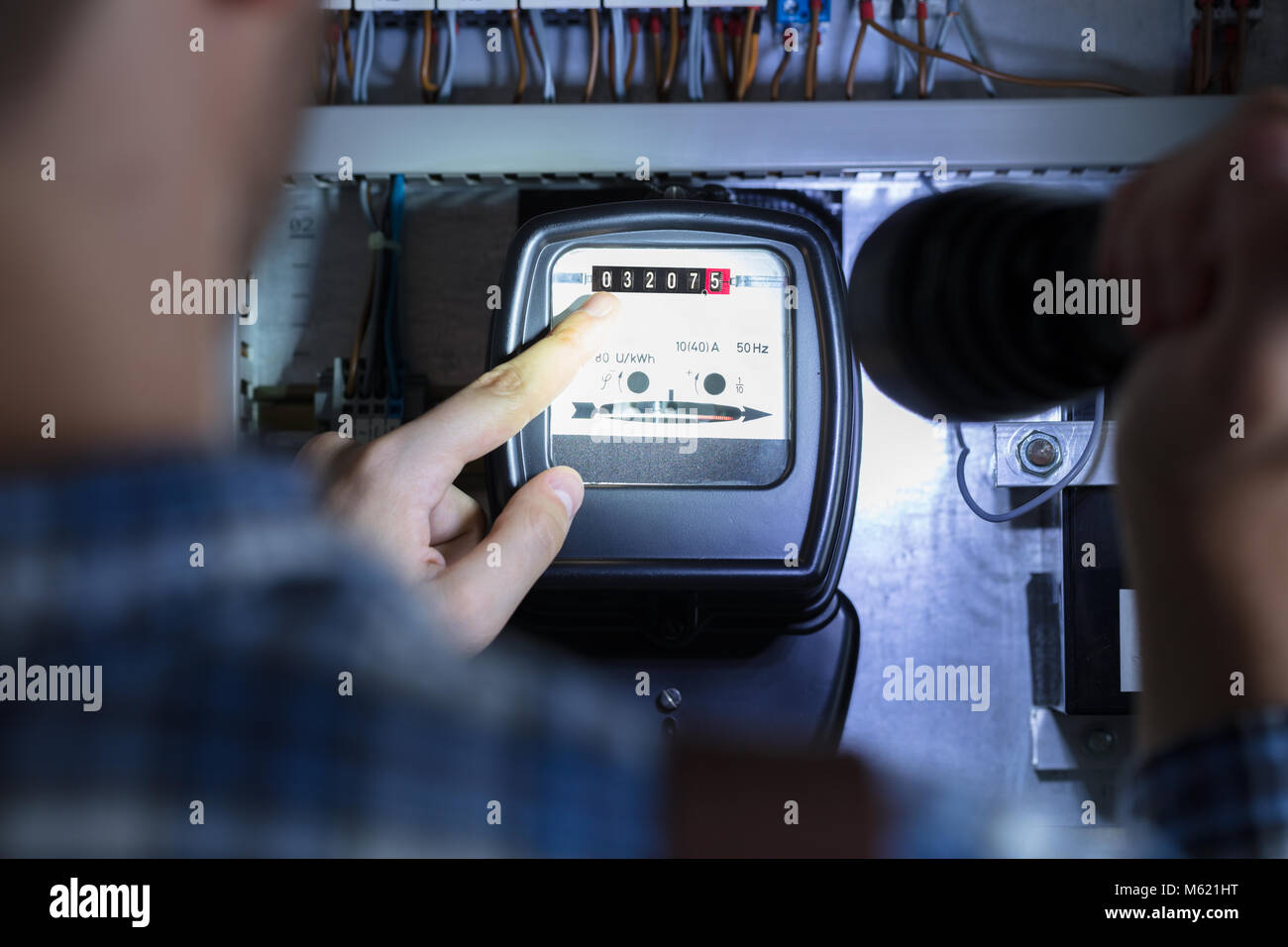 Person's Finger Pointing To Electric Meter Reading Using Flash Light ...