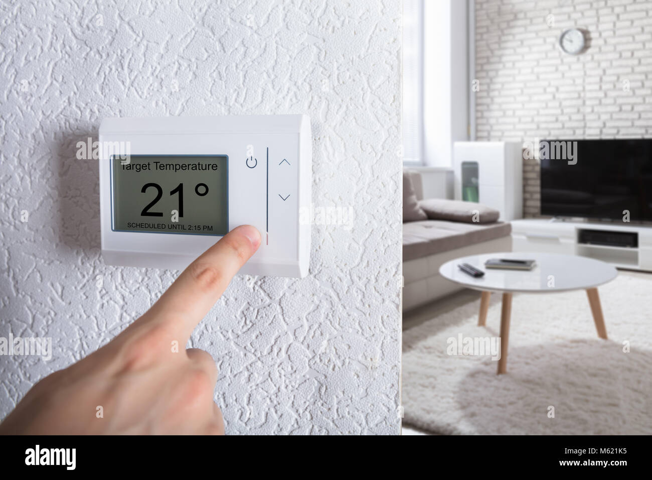 Close-up Of A Person's Hand Adjusting Digital Thermostat At Home Stock ...