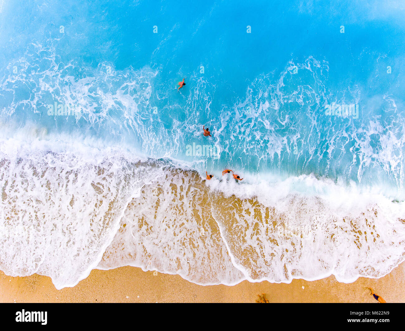 Tourist fighting waves at a beach in Lefkada Greece Stock Photo - Alamy