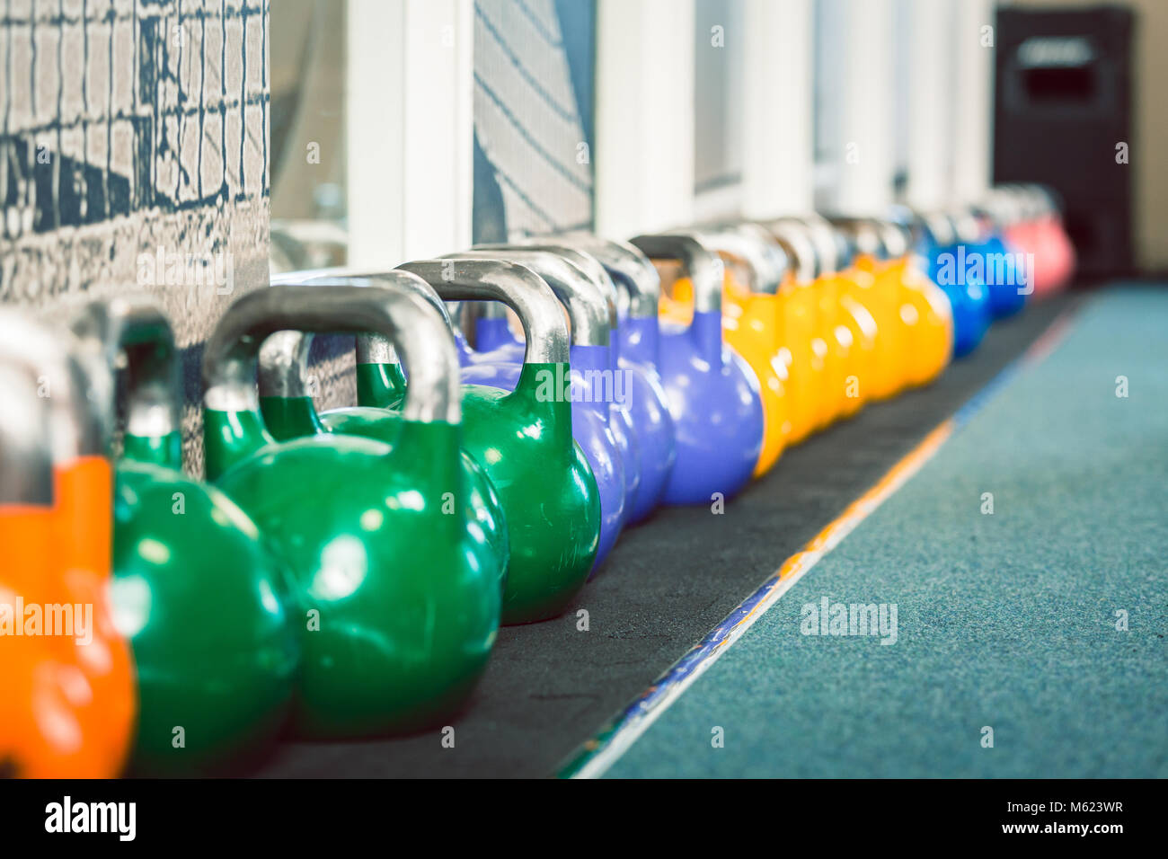 Close-up of kettlebells of various weights and colors Stock Photo - Alamy