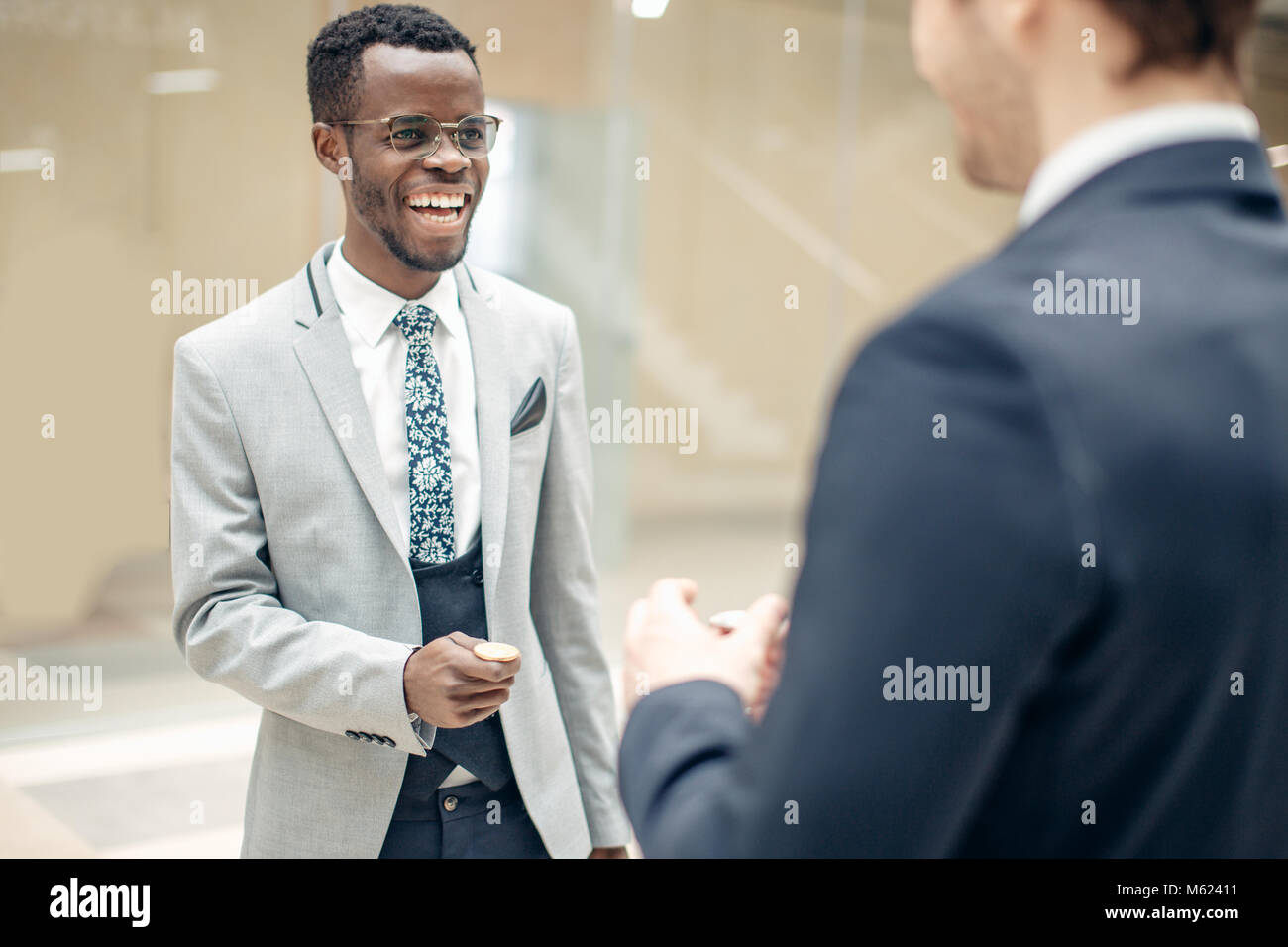 Two multiracial businessman catching hi-res stock photography and ...