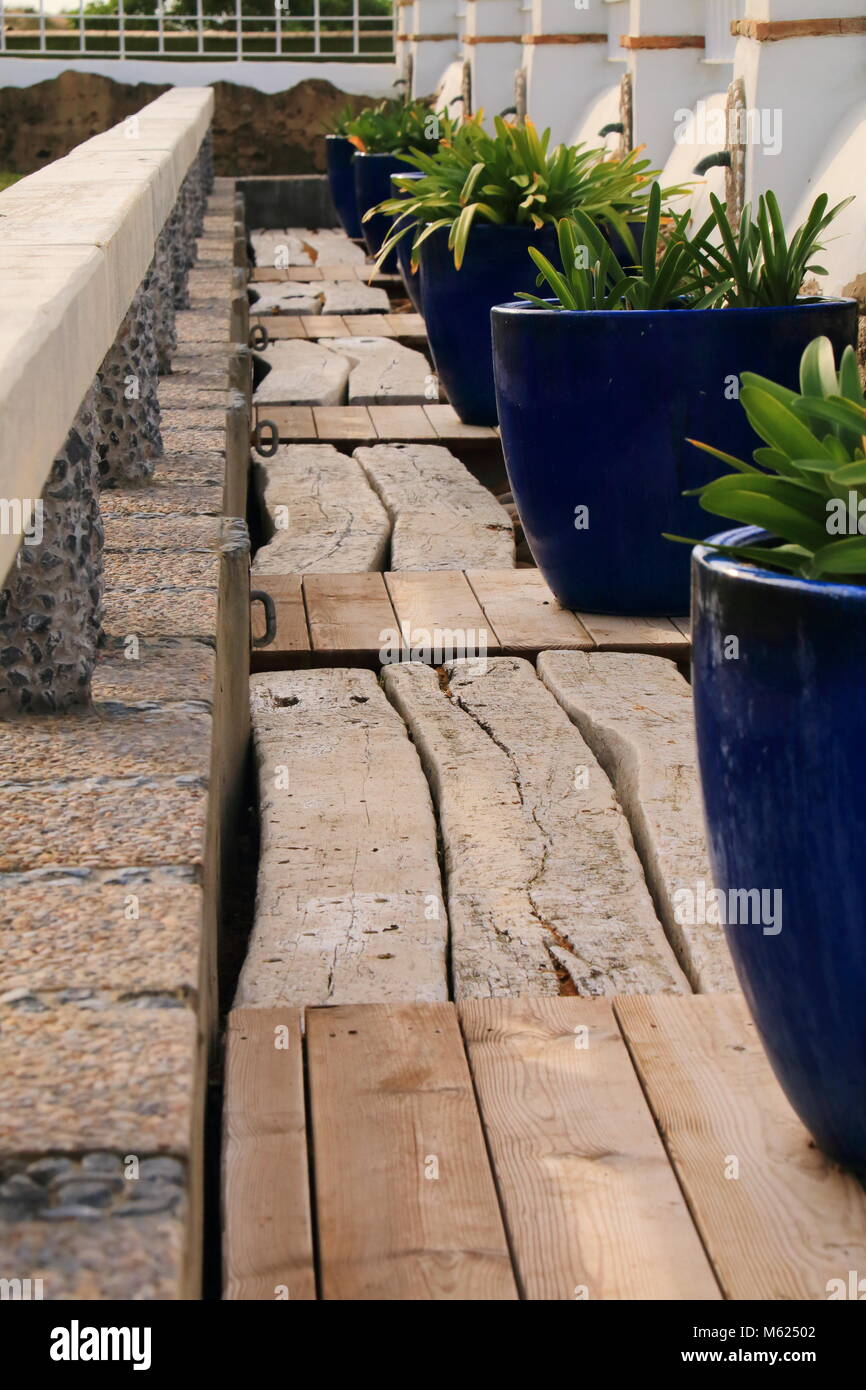 Wooden path in the garden decorated with pots Stock Photo - Alamy