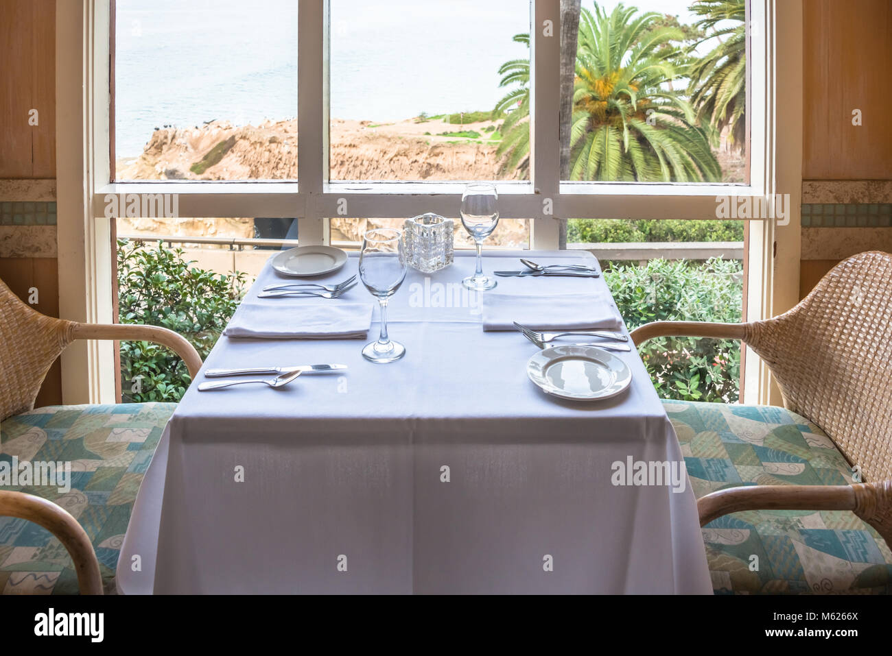 Restaurant Table Setting next to Window with Ocean Beach Stock Photo ...