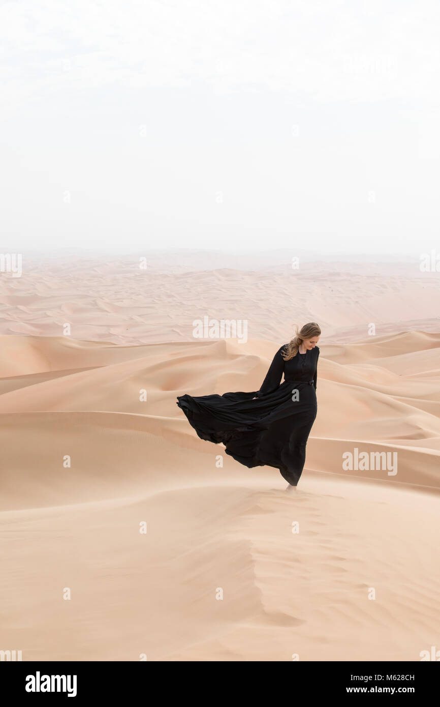 Young beautiful Caucasian woman posing in a traditional Emirati dress ...