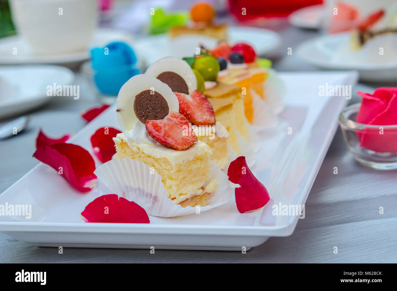 Cake cut into pieces on the table Stock Photo - Alamy