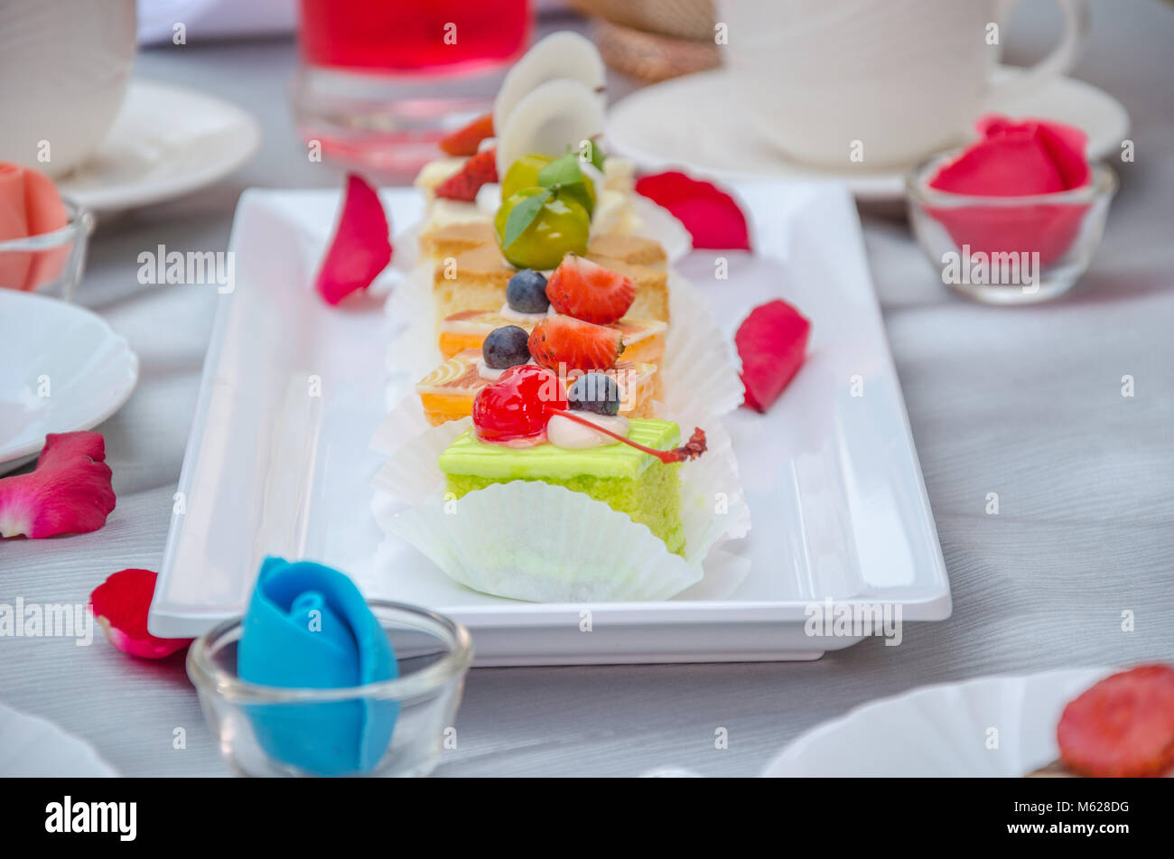 Cake cut into pieces on the table Stock Photo - Alamy