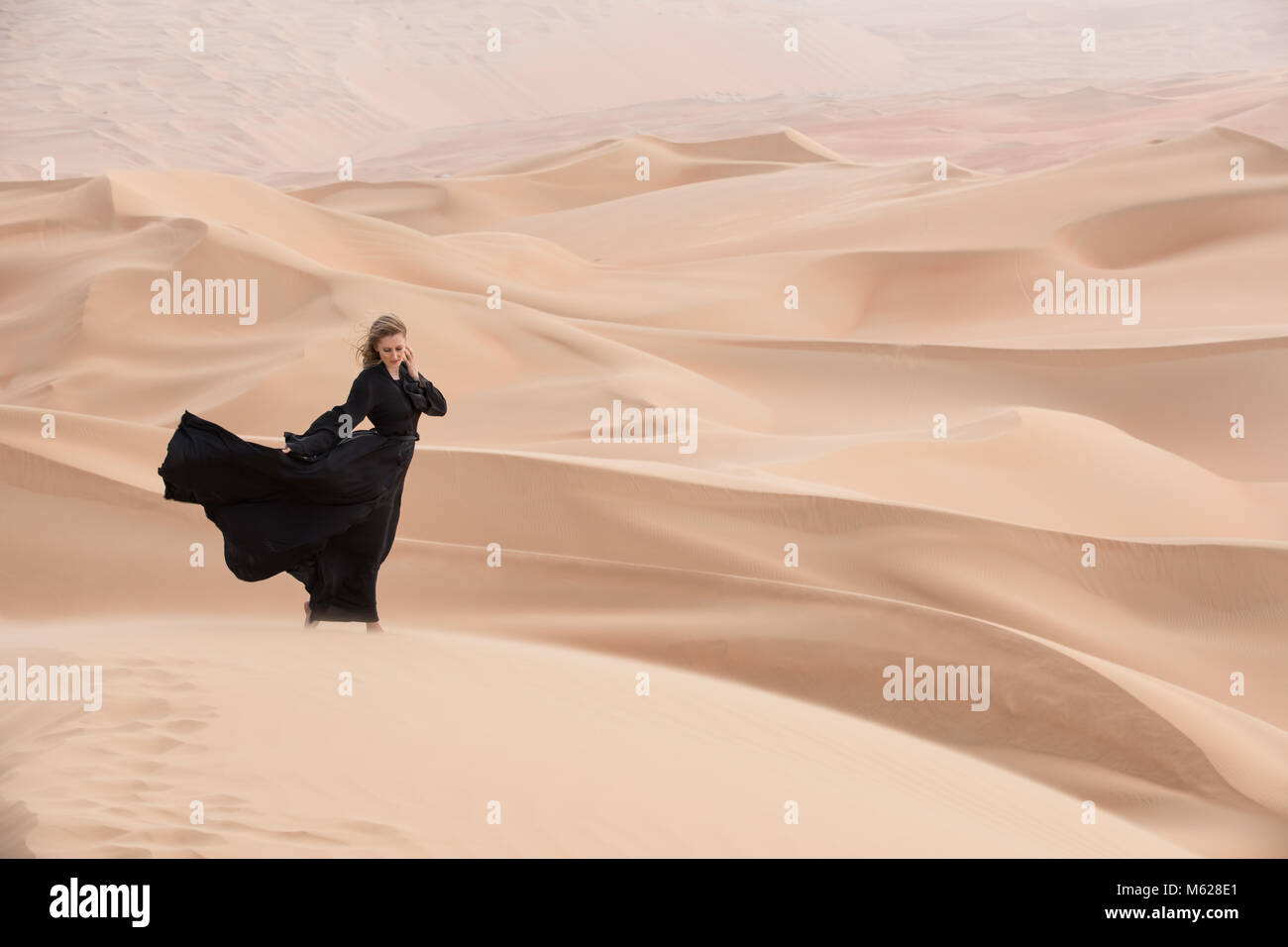 Young beautiful Caucasian woman posing in a traditional Emirati dress ...