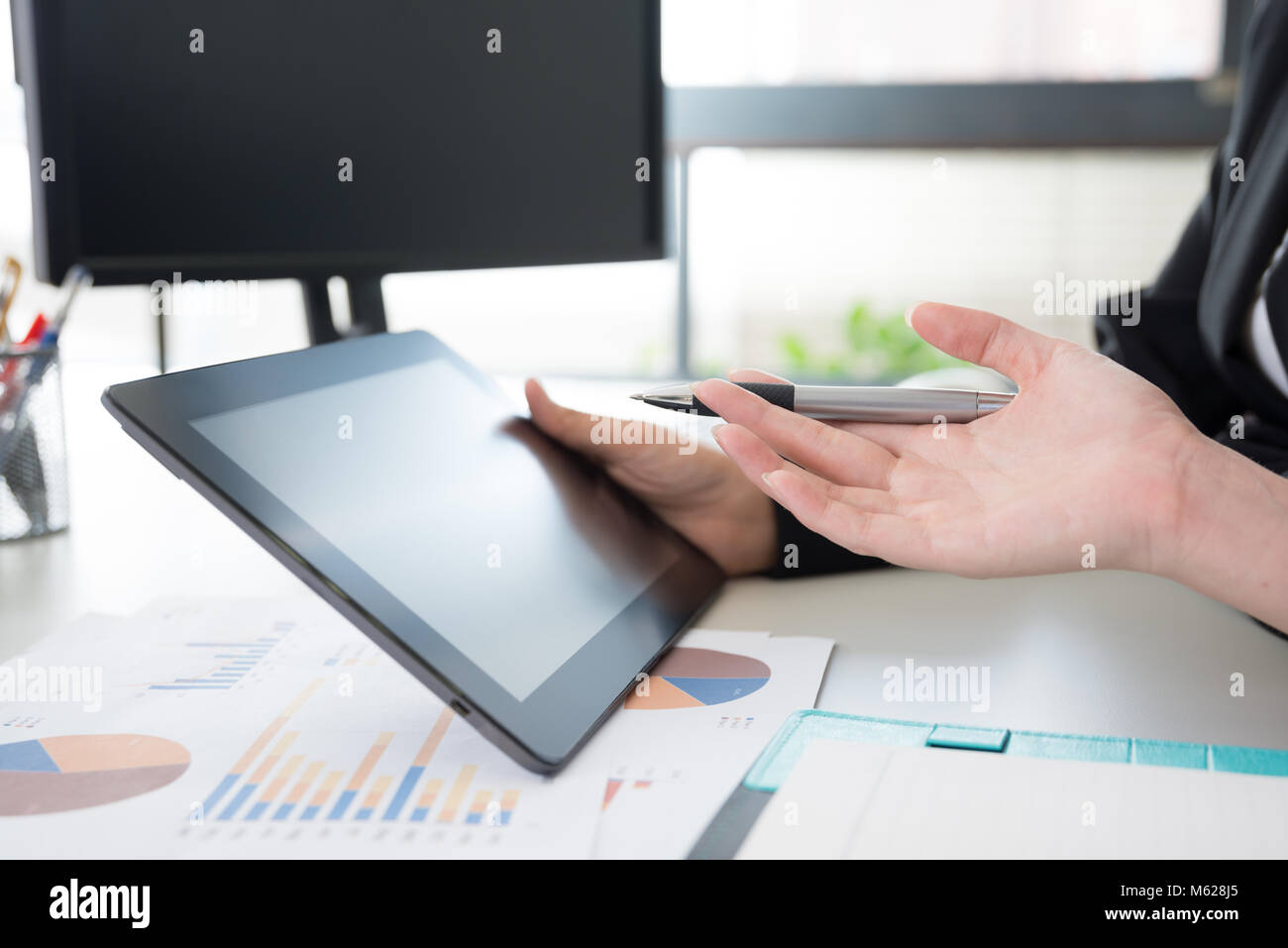 close up of two business woman working on digital tablet pad and ...