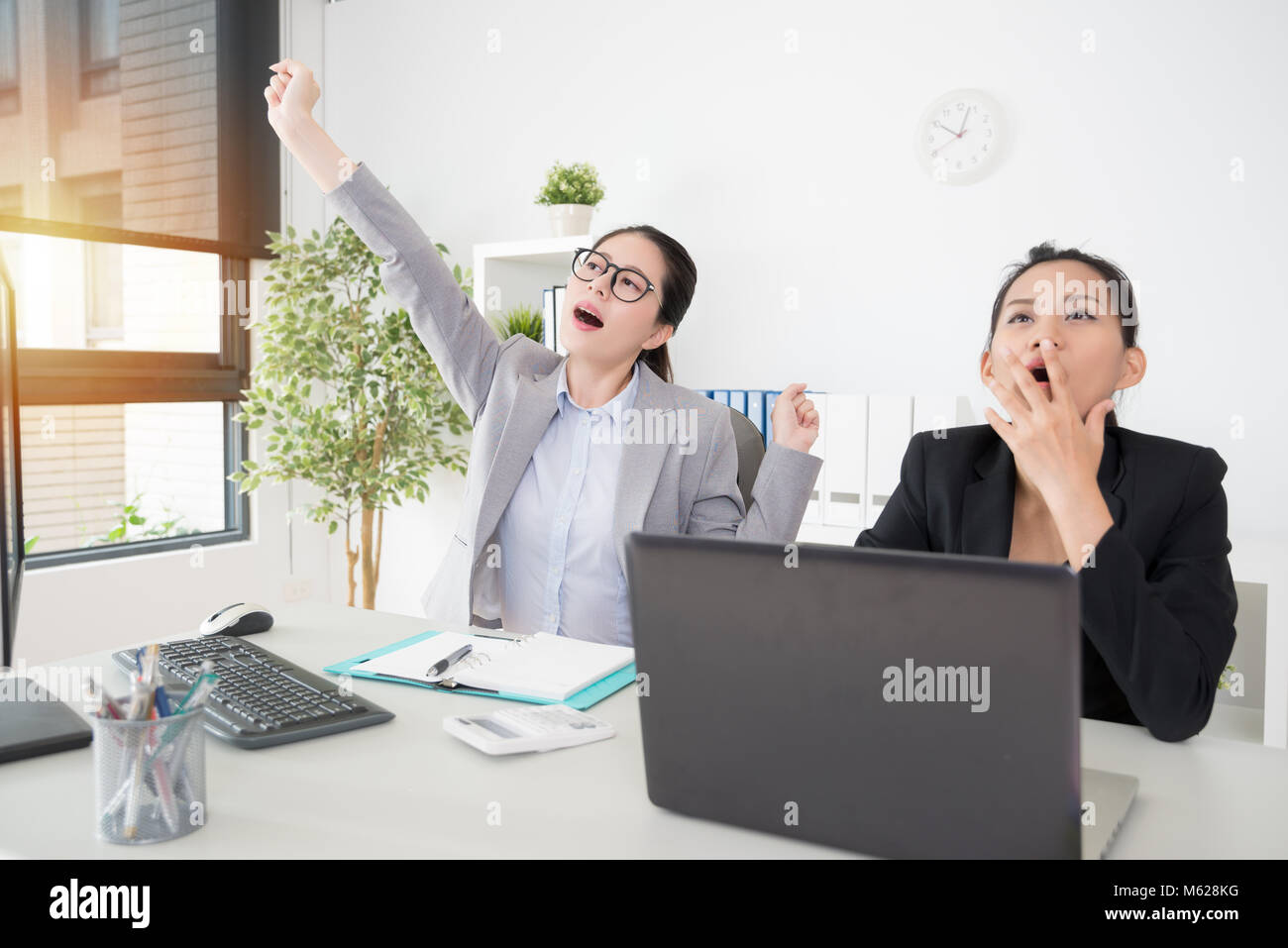 two Asian business women lady feel tired and sleepy after overnight ...