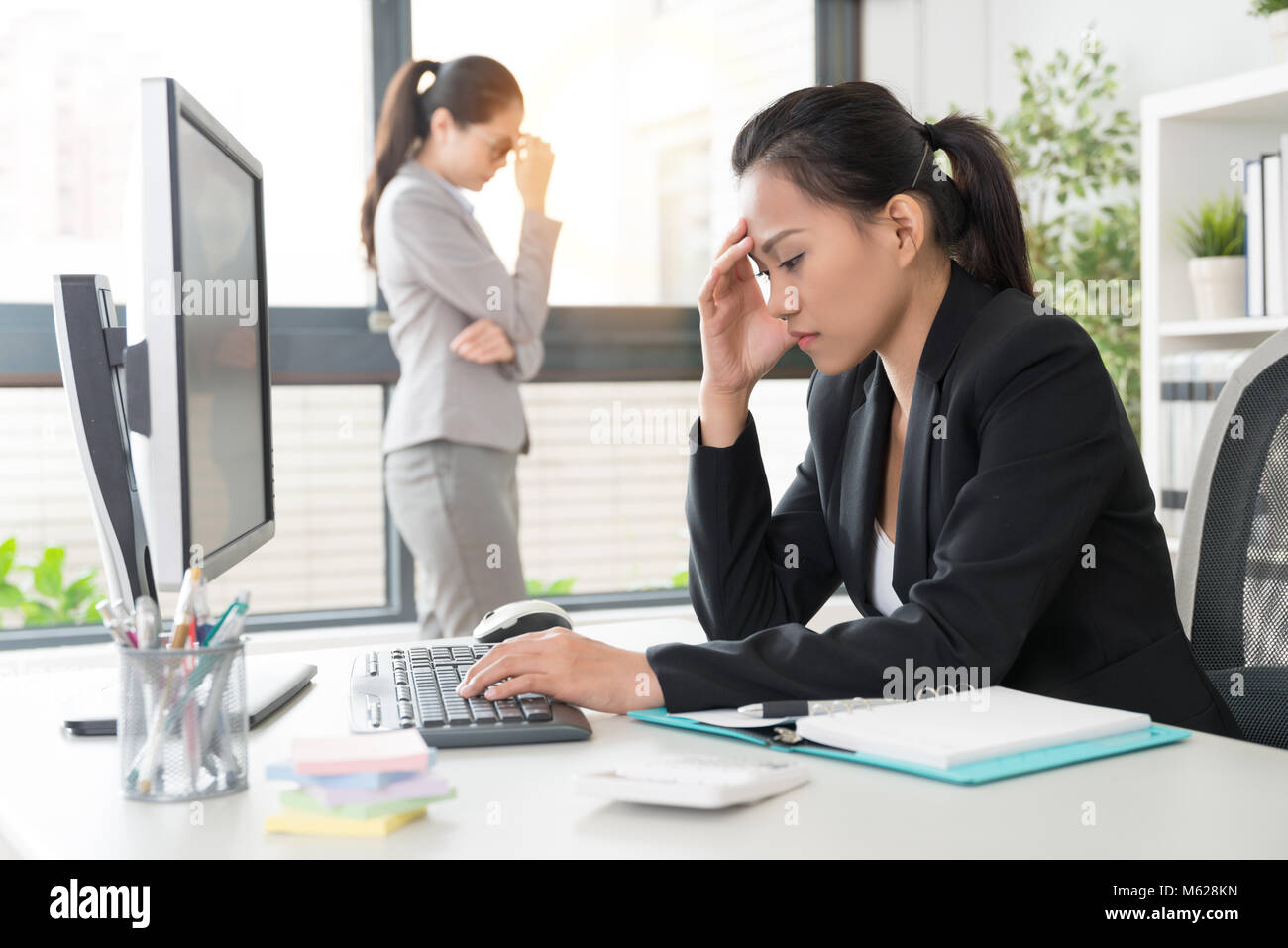 two Asian businesswoman lady got a headache painful of the problem from ...