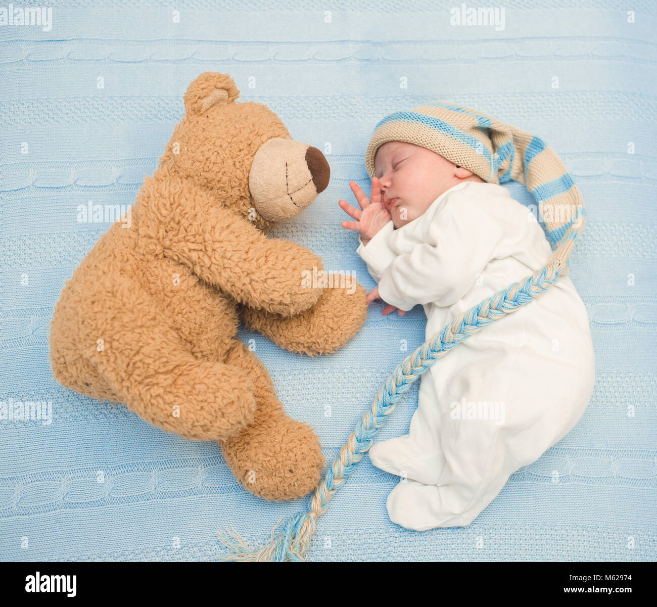 newborn baby laying with teddy bear on blanket Stock Photo - Alamy