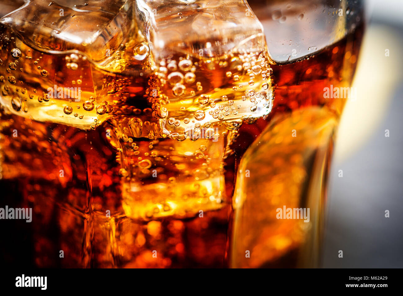 Cold cola drink with bubbles and ice cubes Stock Photo - Alamy