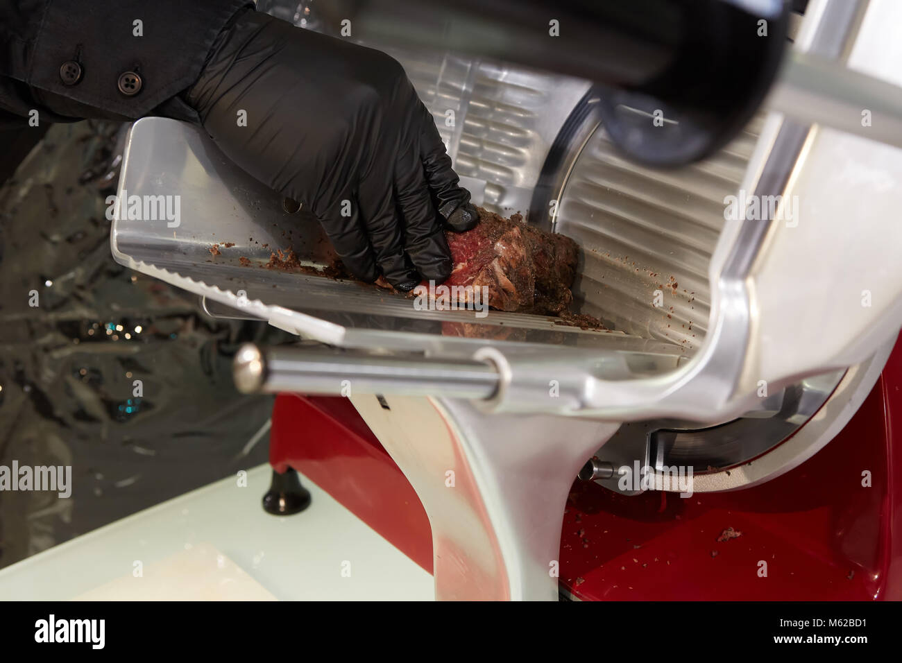 Man slicing meat with machine Stock Photo - Alamy