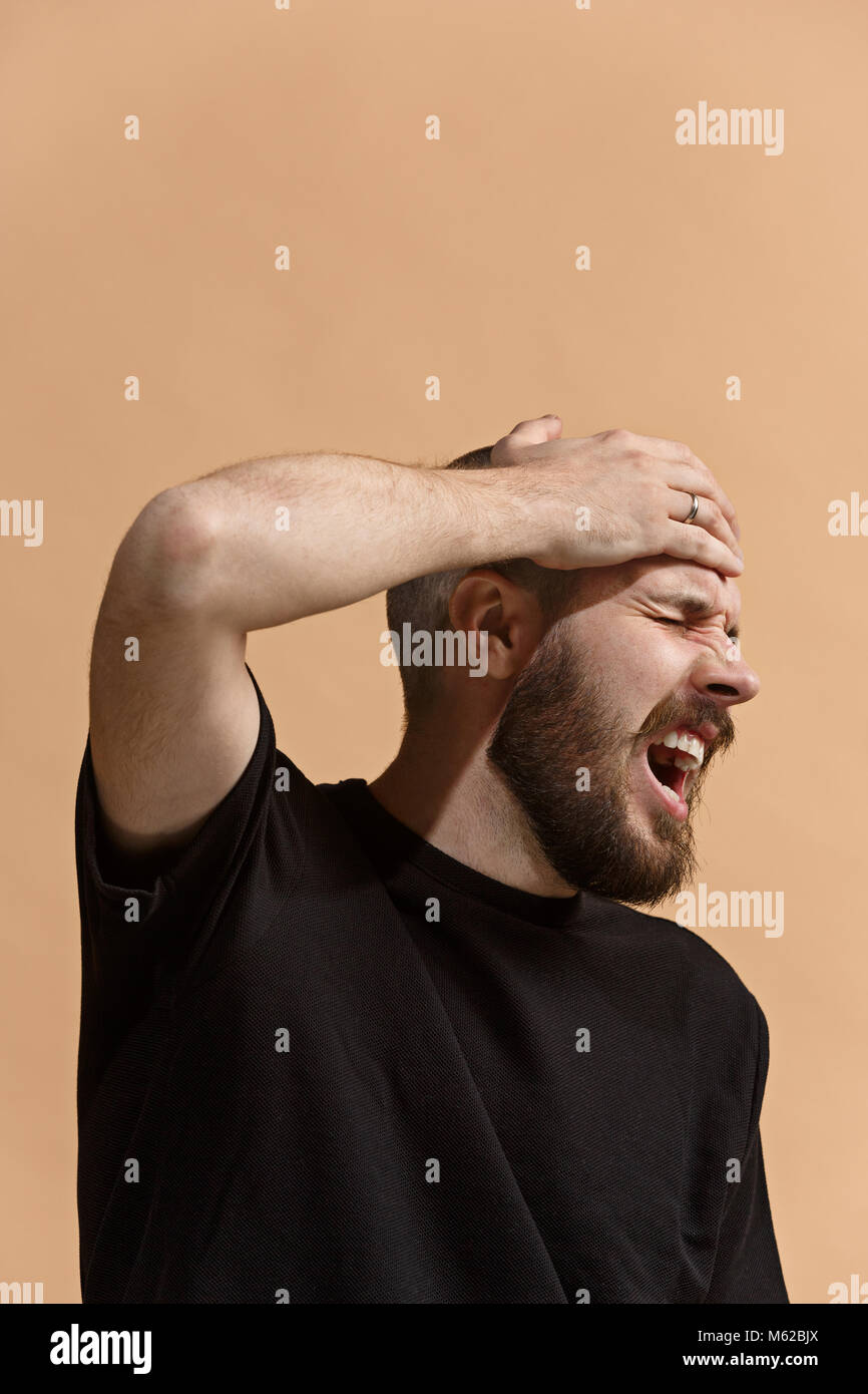 Man having headache. Isolated over pastel background Stock Photo - Alamy