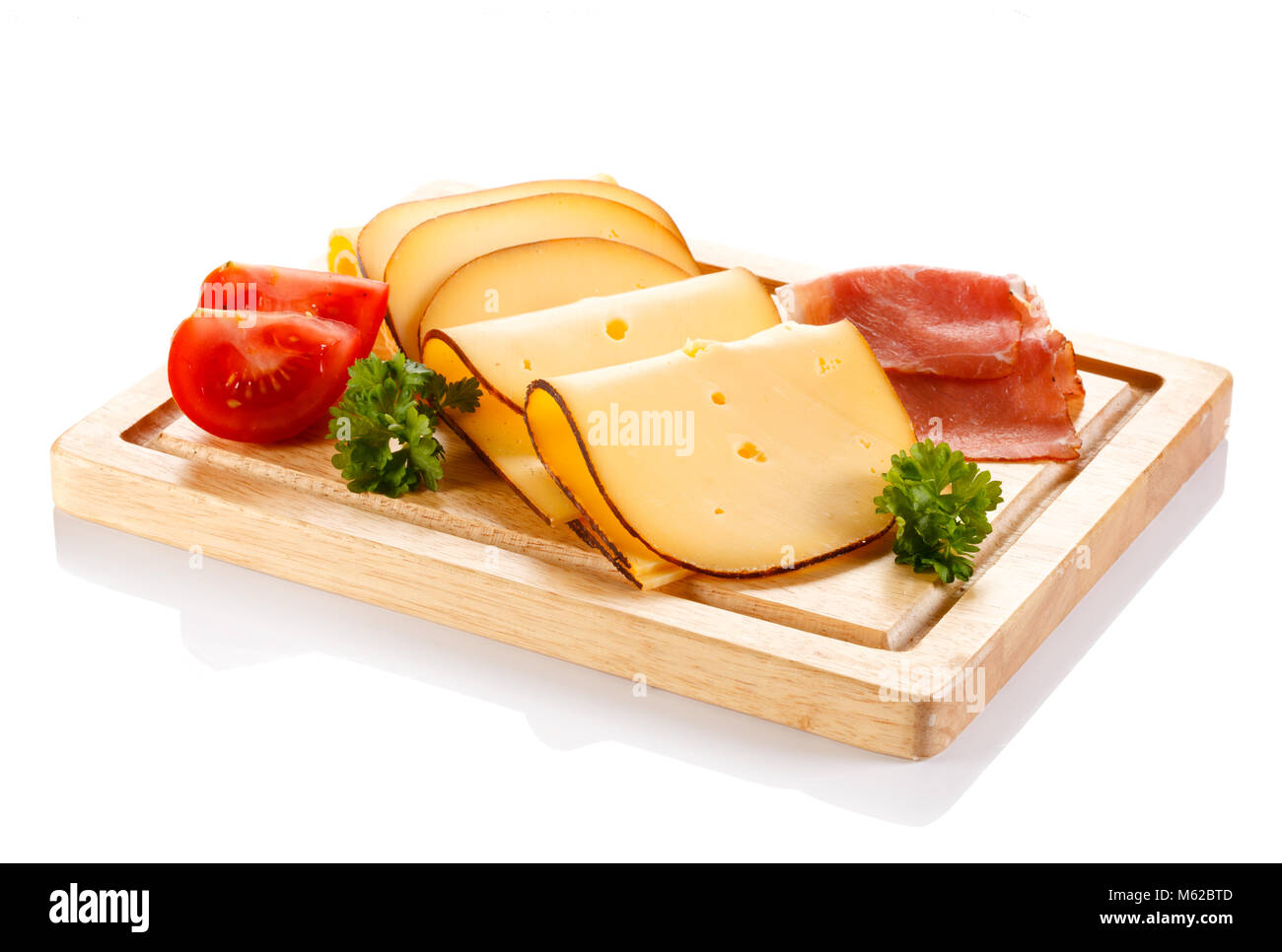 Tasty cheese on board Cut Out Stock Images & Pictures - Alamy