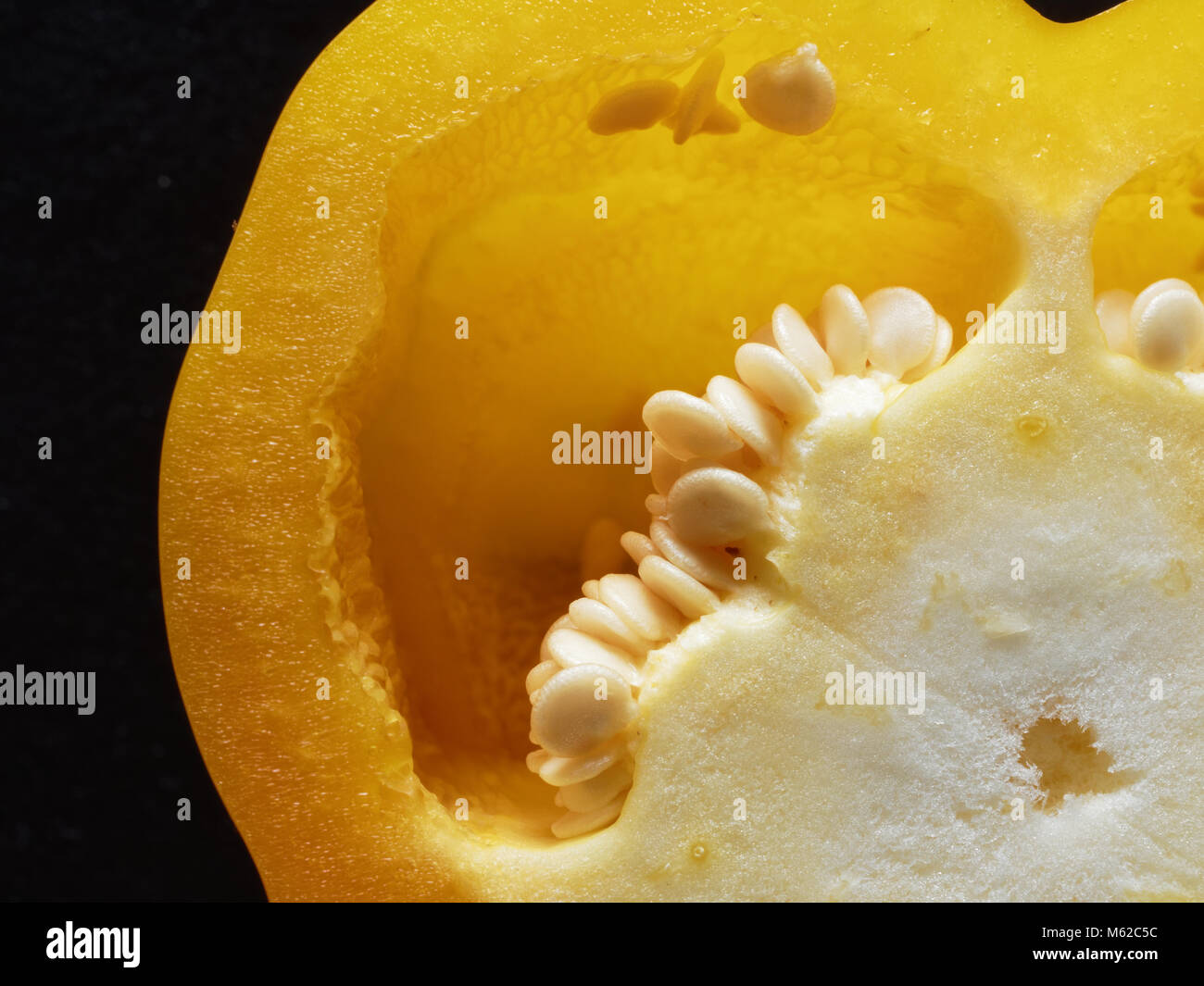 Close up shot of seed, placenta, and pericarp of cut yellow bell pepper ...
