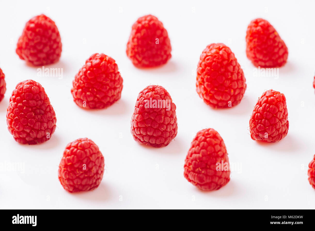 Raspberries arranged on white background Stock Photo - Alamy